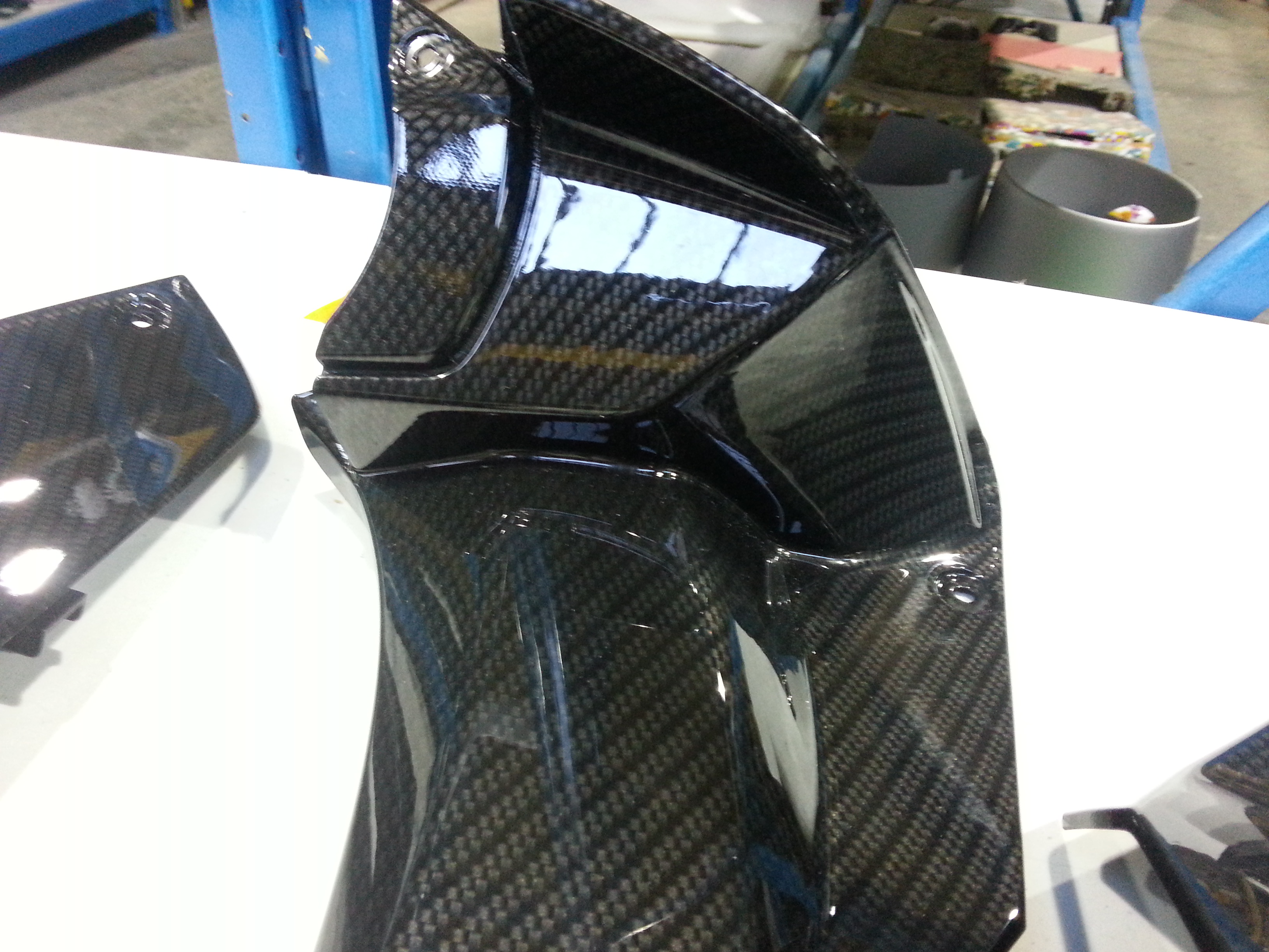 Motorbike parts coated in carbon fibre hydrographic film painted black