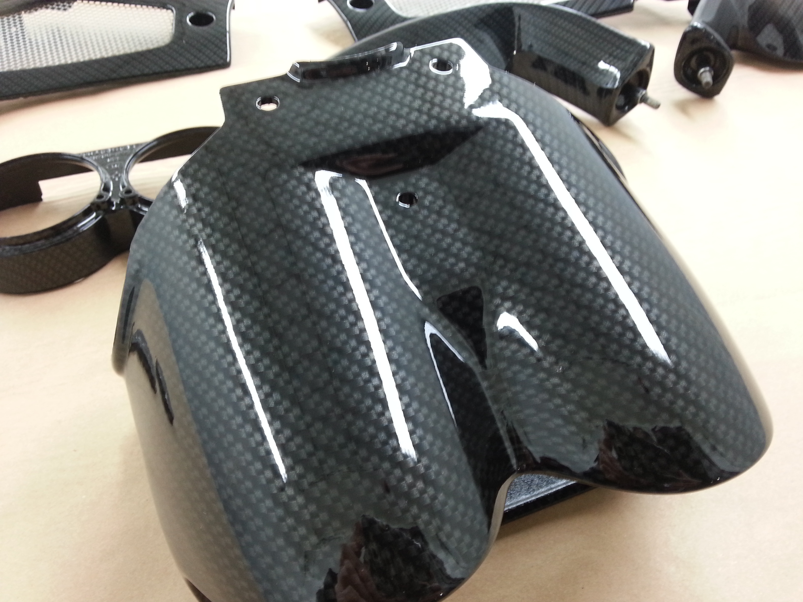 Motorbike elements coated in carbon fibre hydrographic film painted black